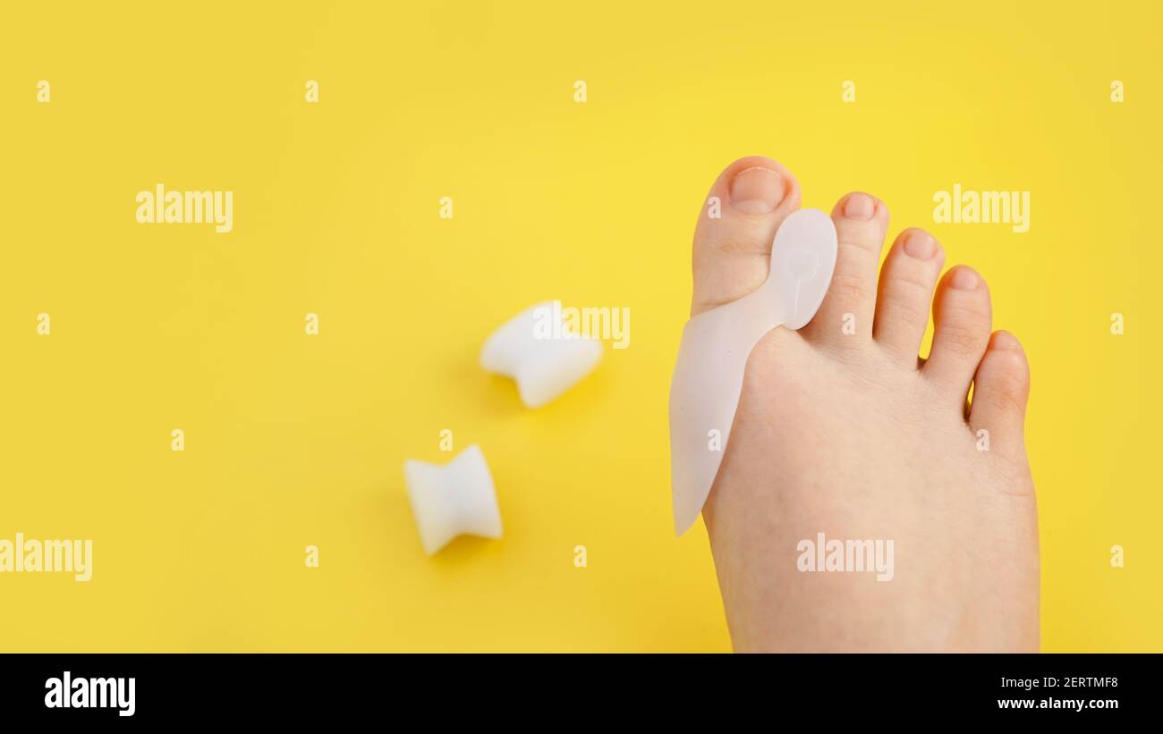 Silicone finger separator. Orthopedic thumb corrector. Legs on a bright ...