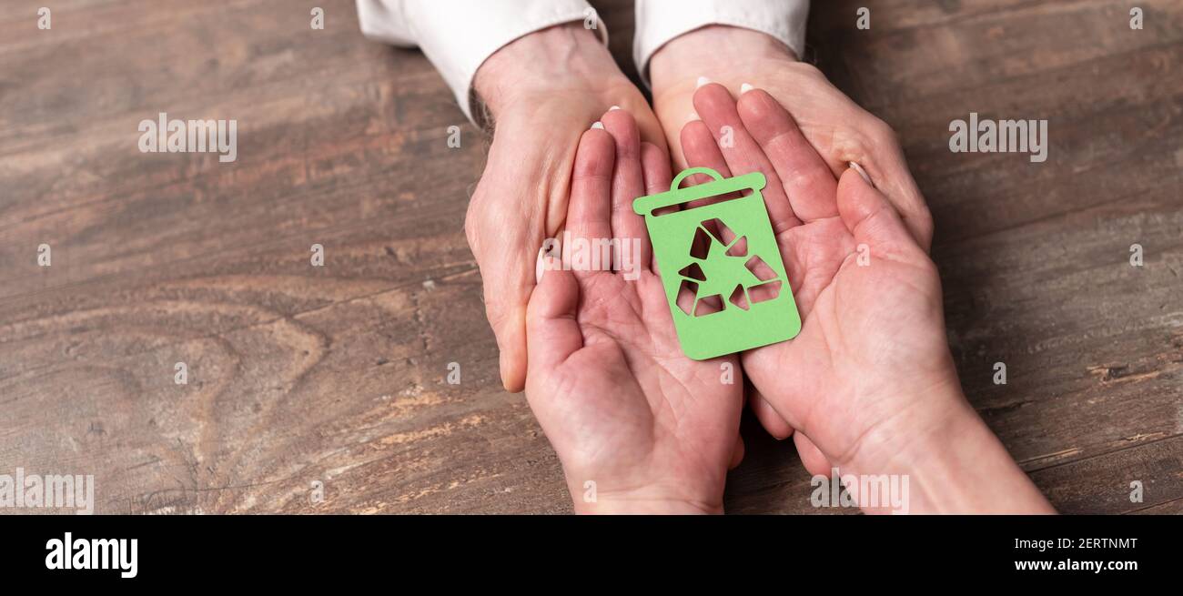 Hands holding a recycling bin; Concept of recycling Stock Photo - Alamy