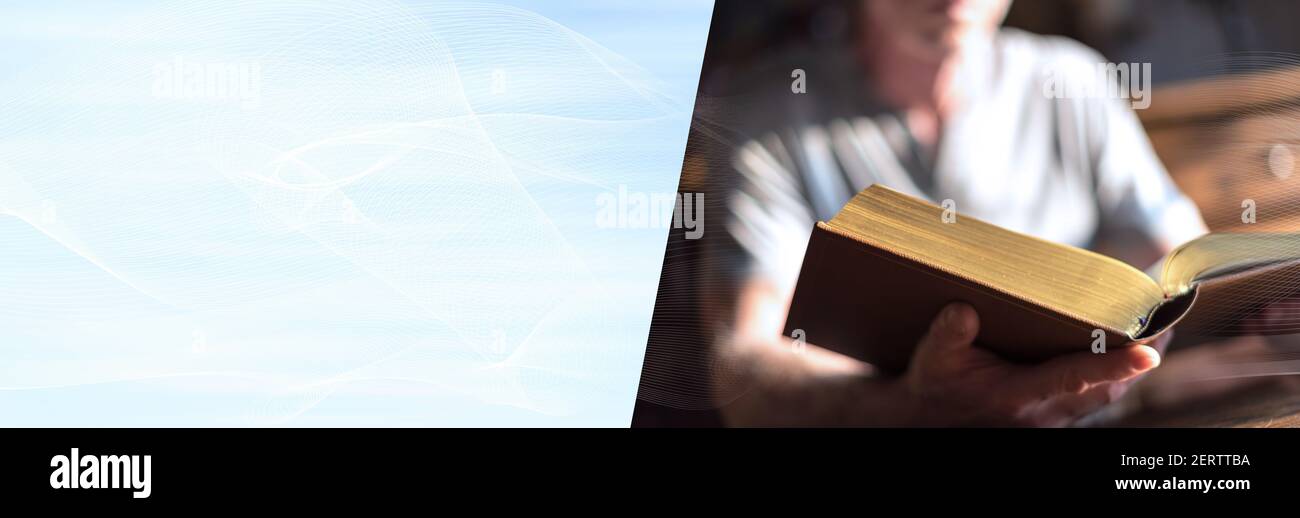 Man reading the bible in dim light; panoramic banner Stock Photo - Alamy