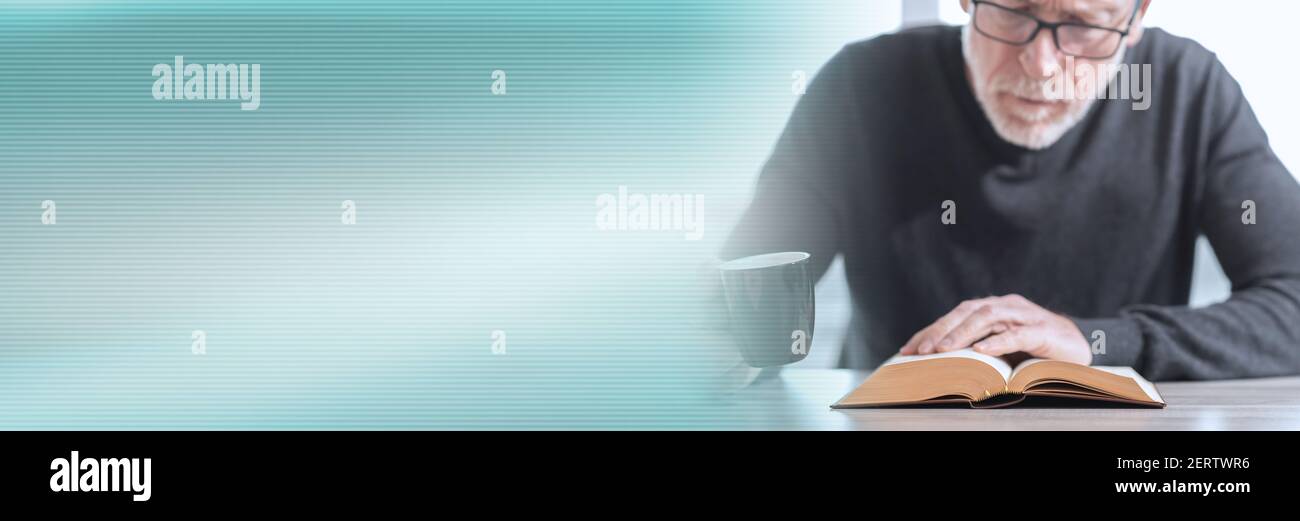 Man sitting and reading a book; panoramic banner Stock Photo - Alamy
