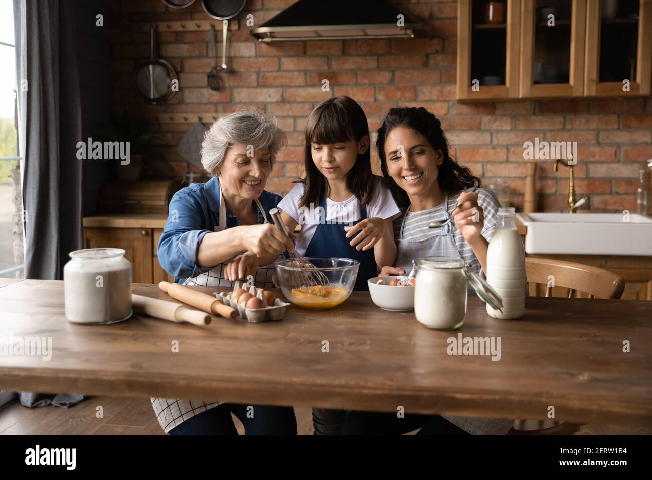 Happy three generations of women cooking together Stock Photo - Alamy