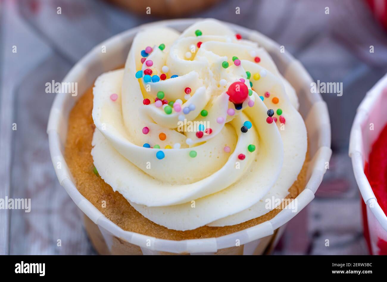 Sweet cream-coloured cake decorated with cream-coloured meringue and ...