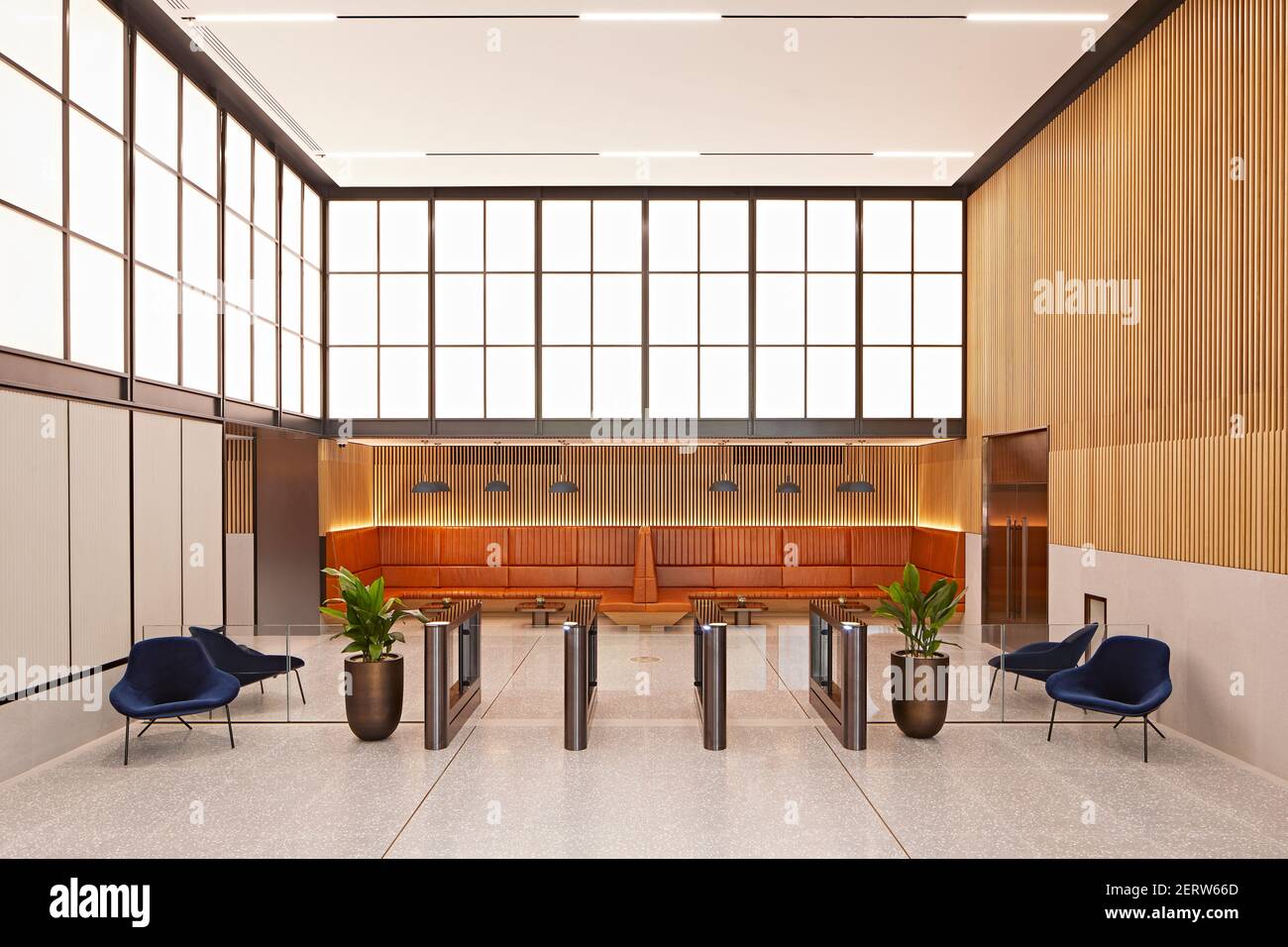 Lobby with rich tan leather seating and large light panels. Premier ...