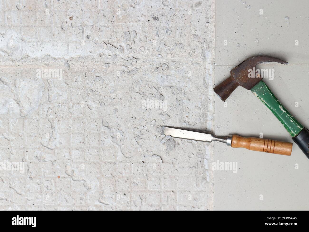 A hammer for hammering nails and a wood chisel is placed beside the ...