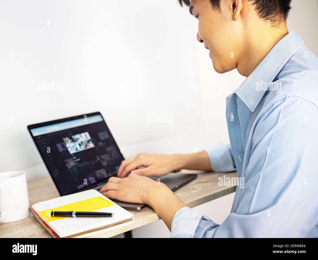 Happy man working on a desk with computer laptop Stock Photo - Alamy