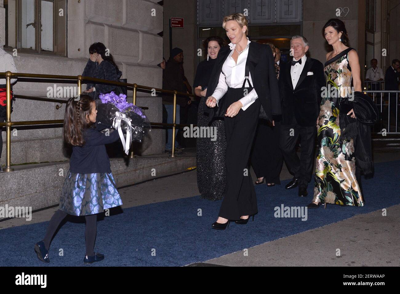 Princess Charlene of Monaco is handed a bouquet of flowers by Ilusina ...