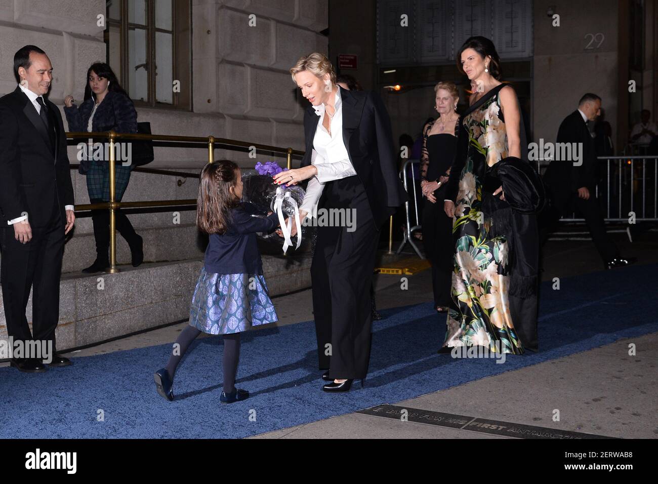 Princess Charlene of Monaco is handed a bouquet of flowers by Ilusina ...