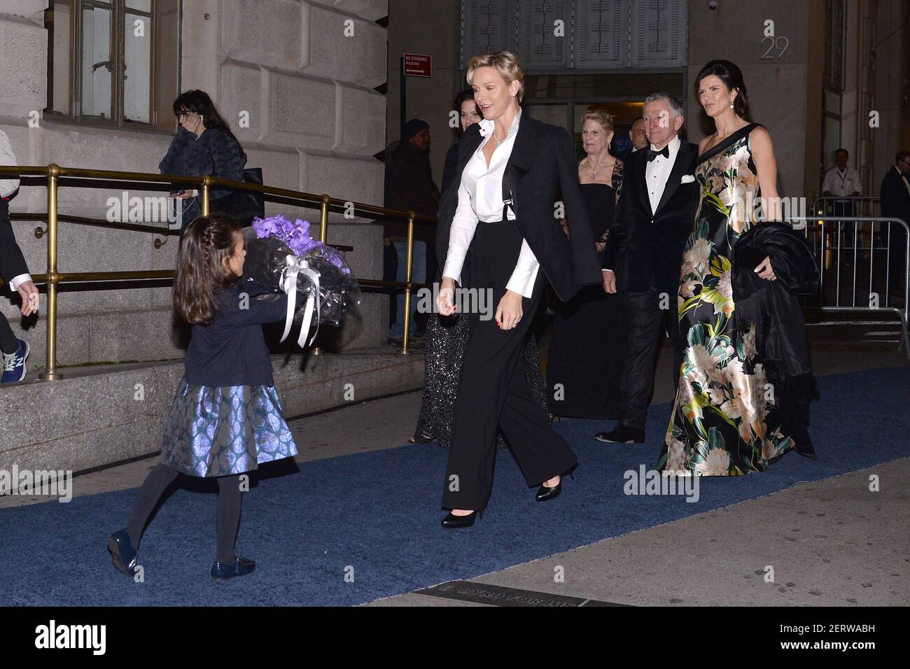 Princess Charlene of Monaco is handed a bouquet of flowers by Ilusina ...