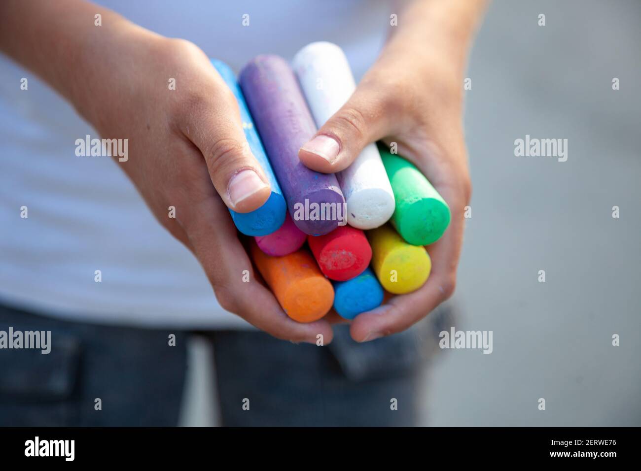 Chalks. Large multi-colored crayons in children's hands. The child ...