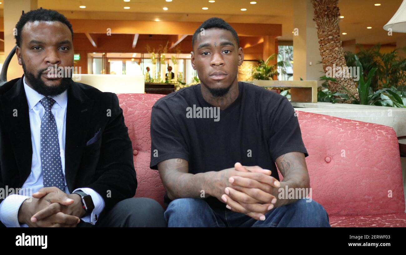 Terrence Harmon, at right with attorney Lee Merritt, was in the ...