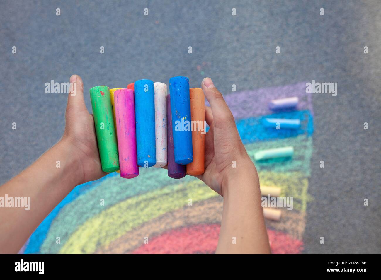 Chalks. Large multi-colored crayons in children's hands. The child ...