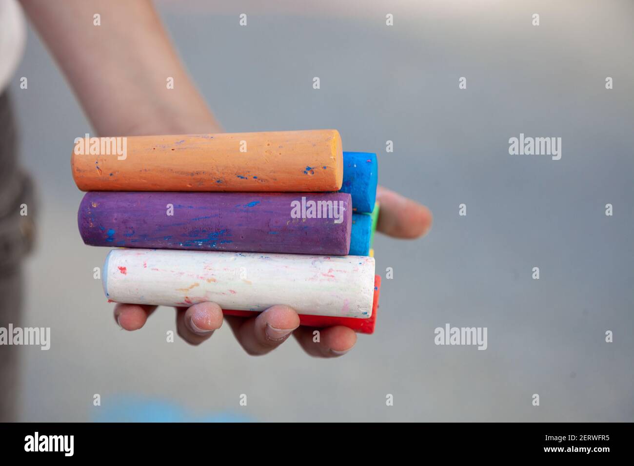 Chalks. Large multi-colored crayons in children's hands. The child ...