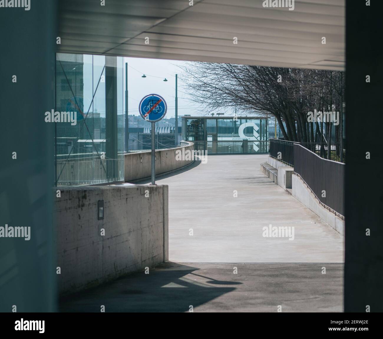 Street photography of a brightly lit alley way and Train line overhead ...