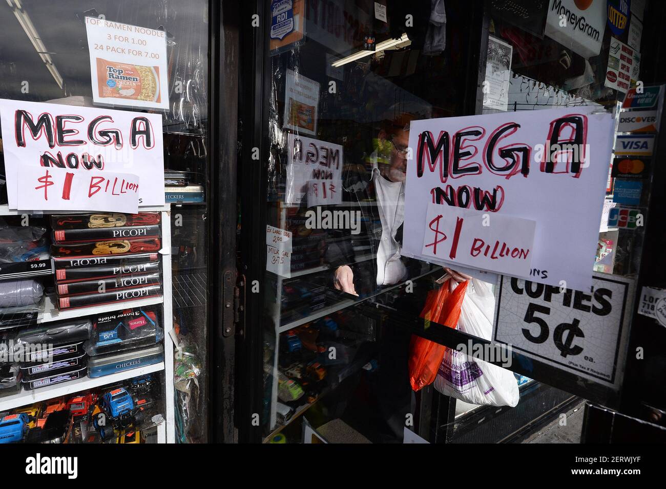 Signage on a storefront for the Mega Millions Jackpot Lottery which is ...