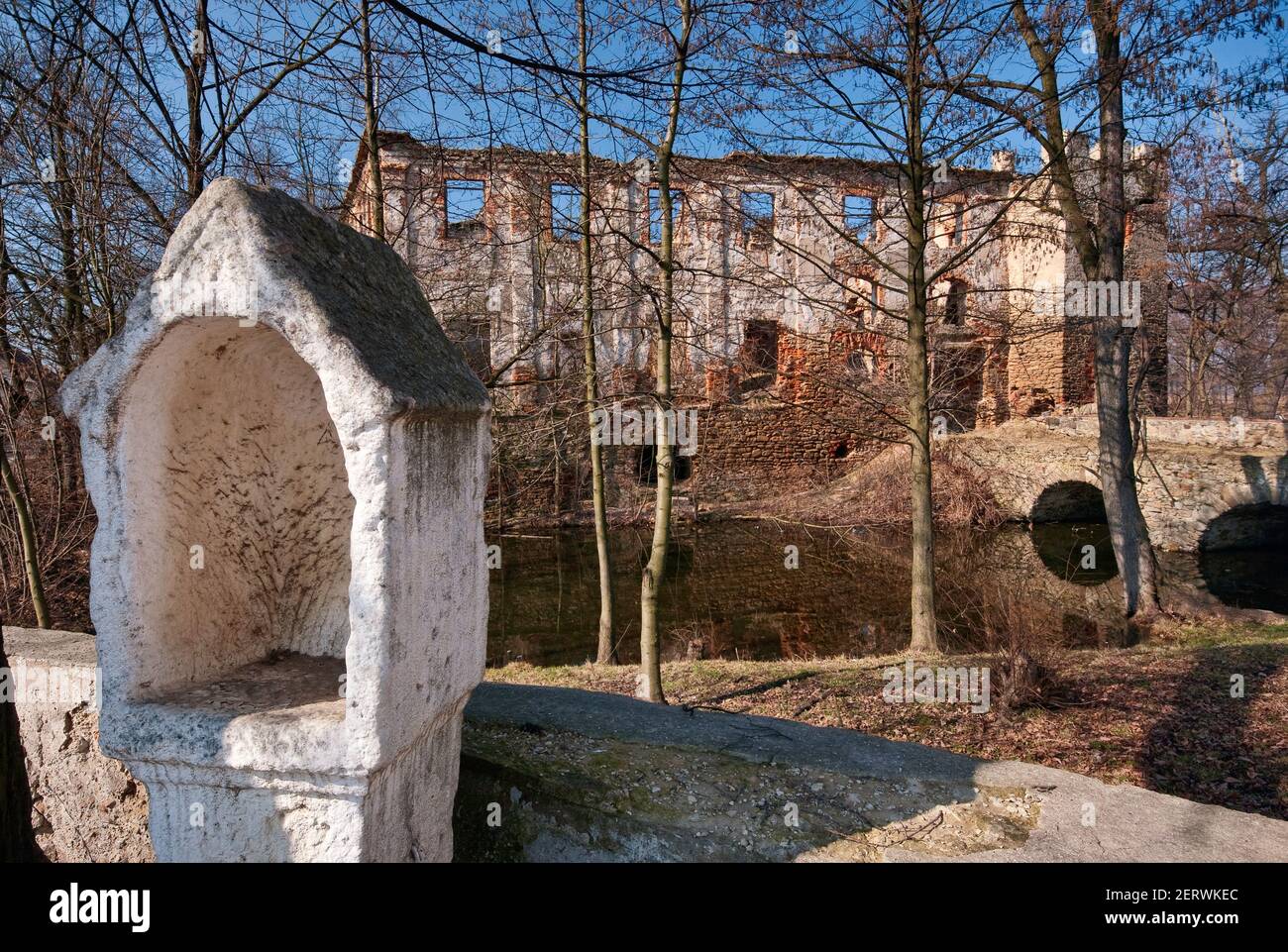 Empty roadside shrine and ruined medieval castle on island at lake in ...