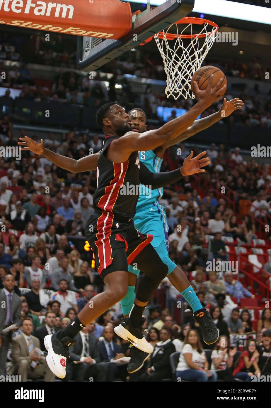 The Miami Heat's Dwyane Wade, left, goes to the basket against the ...