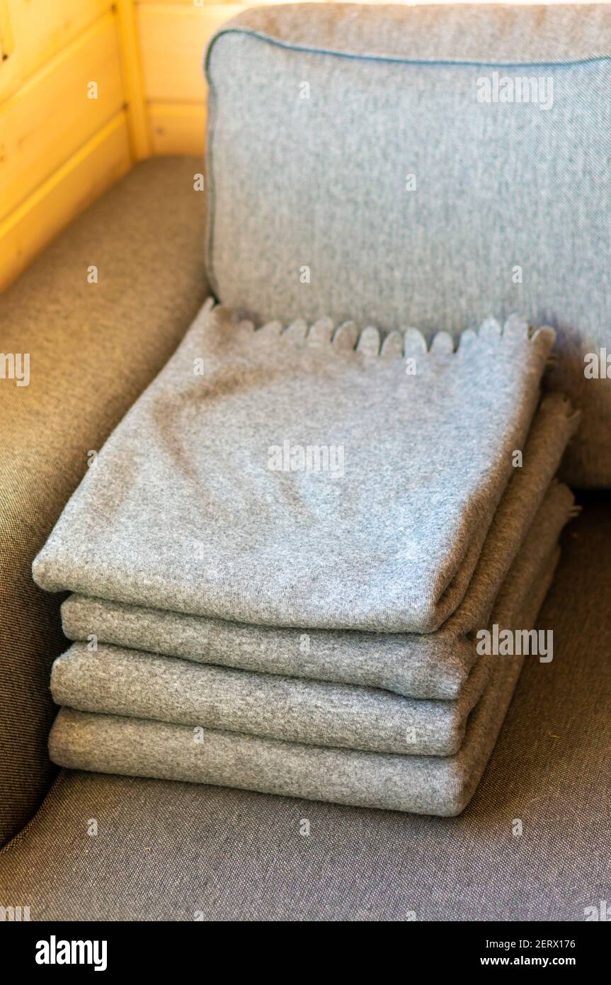 Pile of warm blankets on a sofa Stock Photo - Alamy