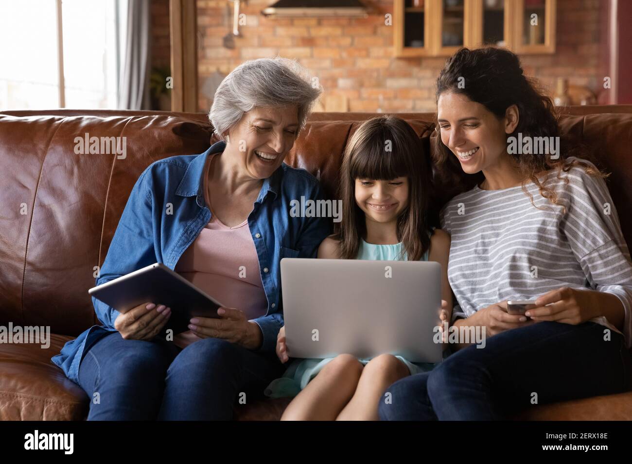 Family using electronic gadgets hi-res stock photography and images - Alamy