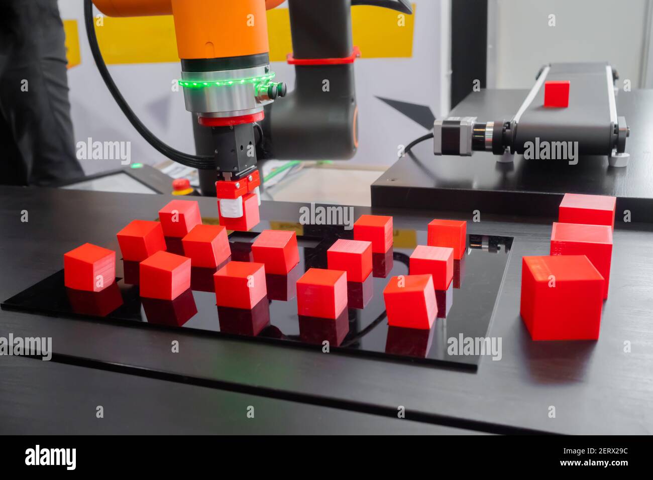 Pick and place robotic arm manipulator moving red toy blocks at robot exhibition Stock Photo - Alamy