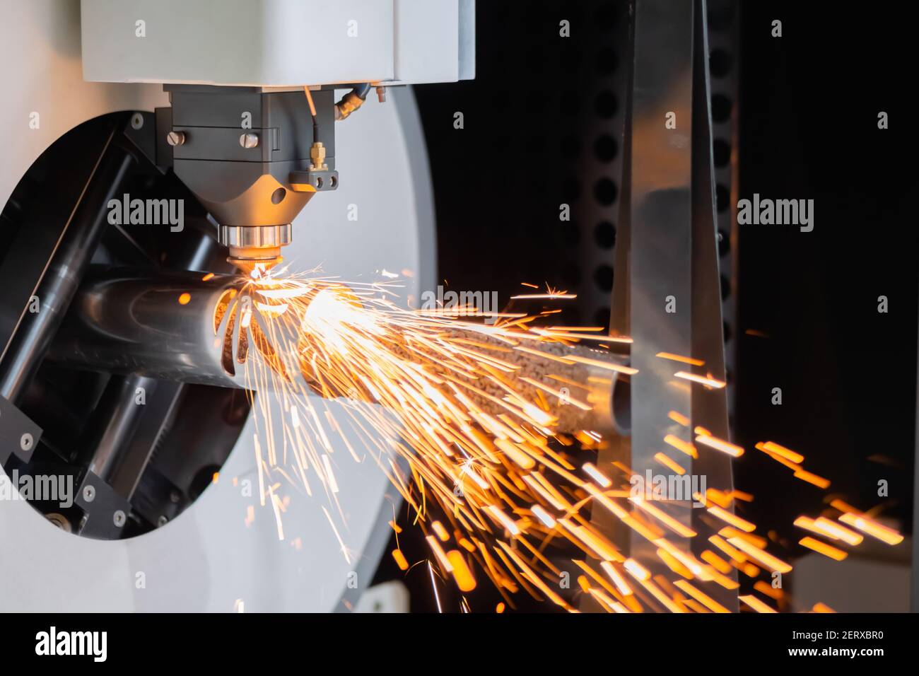 Laser cutting machine working with cylindrical metal workpiece with ...