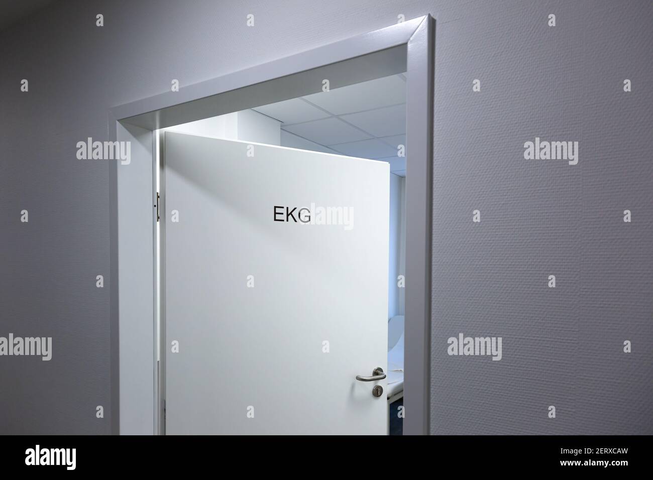a half open white door to the ECG room (EKG) in a doctor's surgery ...