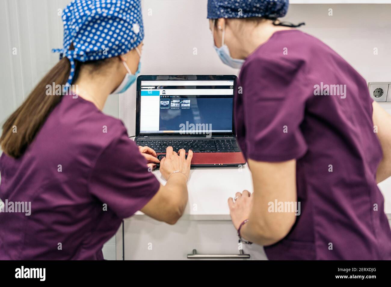Stock photo of female dentist and her coworker using computer in dental ...