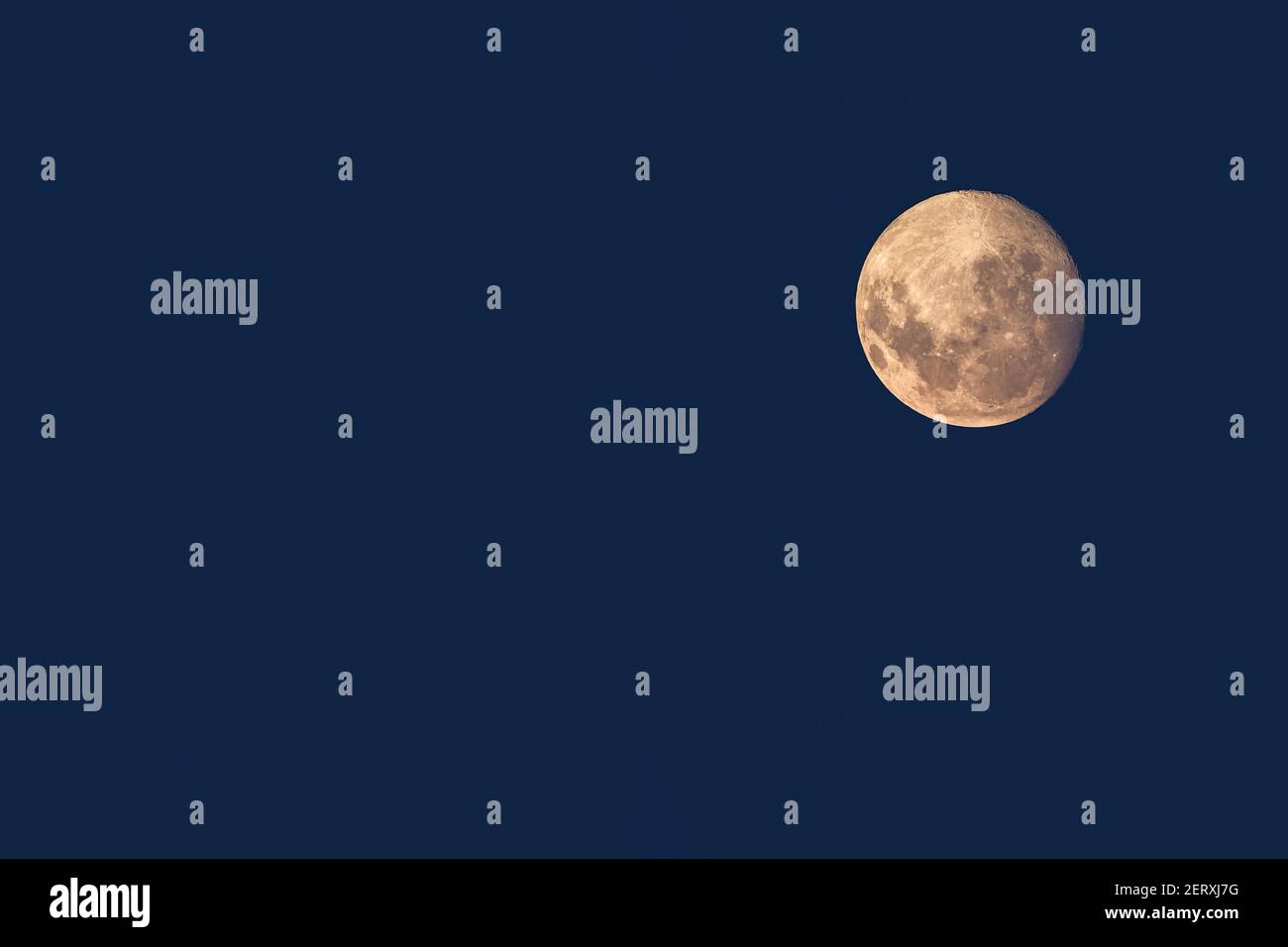 Full super moon glowing against blue sky dark background Stock Photo ...