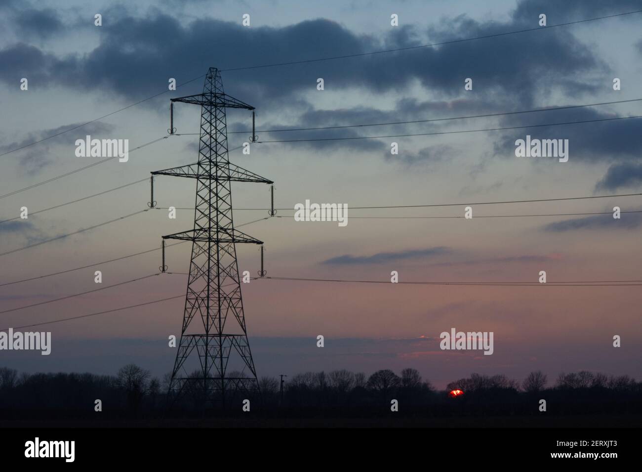 Sunset with silhouetted high voltage electricity pylon of the National ...