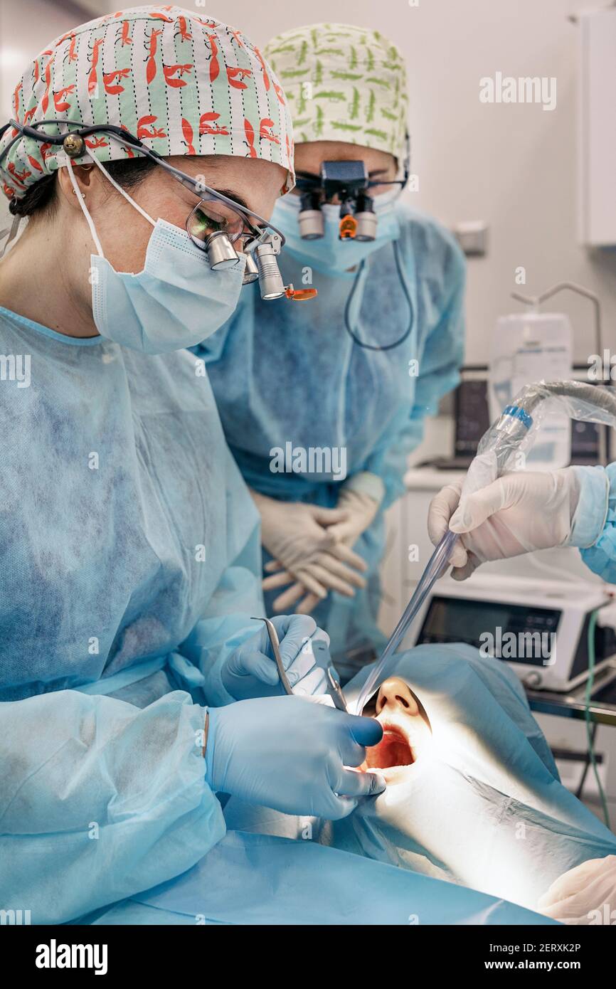 Stock photo of women team wearing face masks and hair nets working in ...