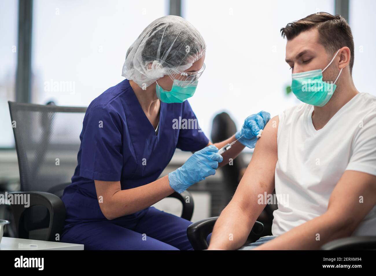 In the laboratory at the hospital, a nurse gives an injection into the ...