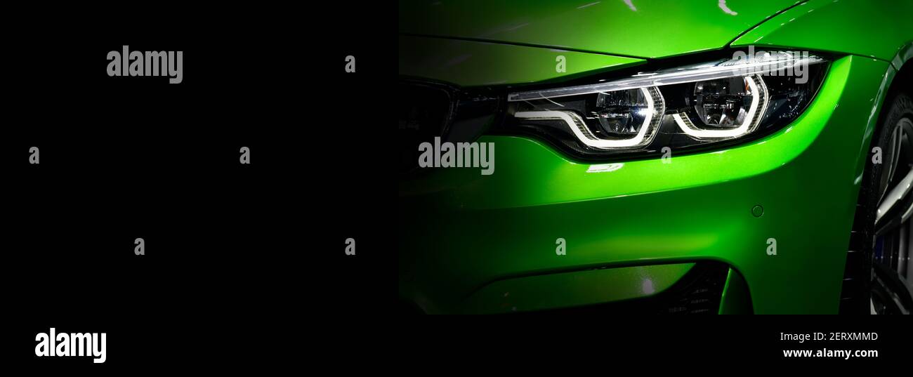 Close up detail green modern car headlights with led technology on ...