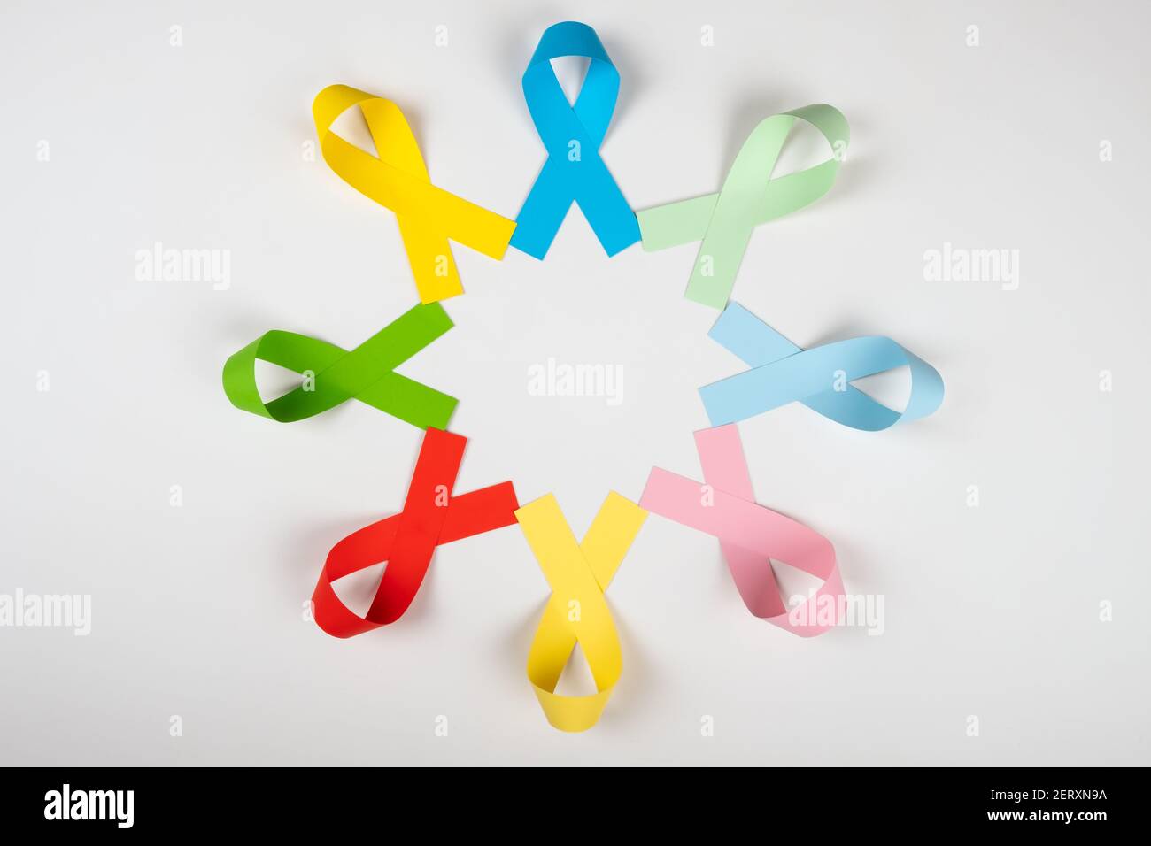 circle of multi color awareness ribbons on white background top view ...