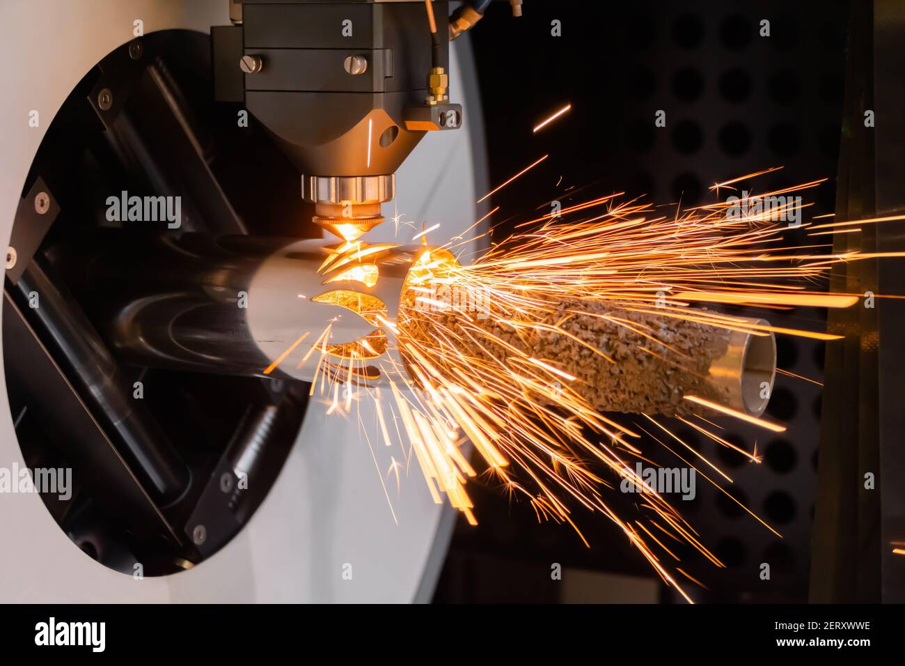 Laser cutting machine working with cylindrical metal workpiece with ...