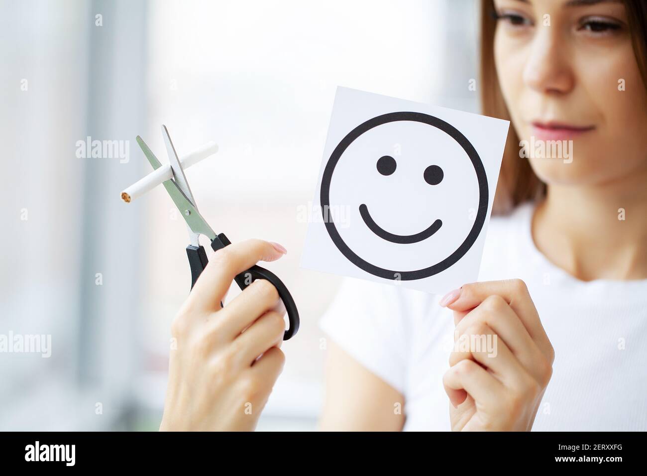 Stop smoking, woman cuts a cigarette with scissors Stock Photo - Alamy