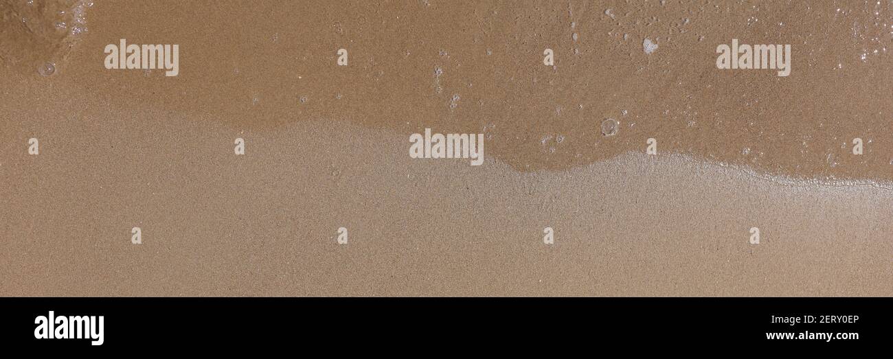 Wet sand on beach and sea water on surf Stock Photo - Alamy