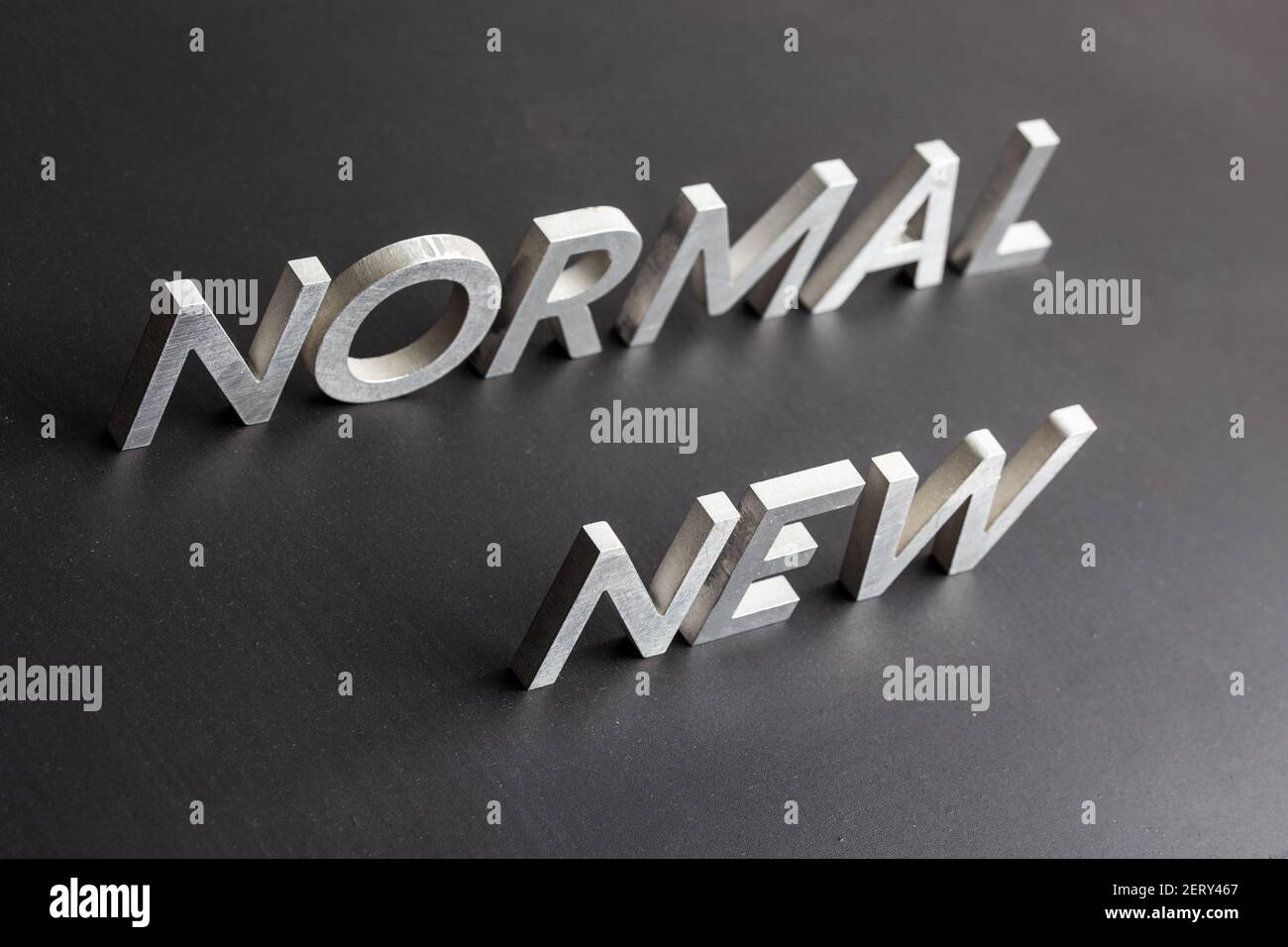 new normal word composed of silver metal letters on a flat matt black ...