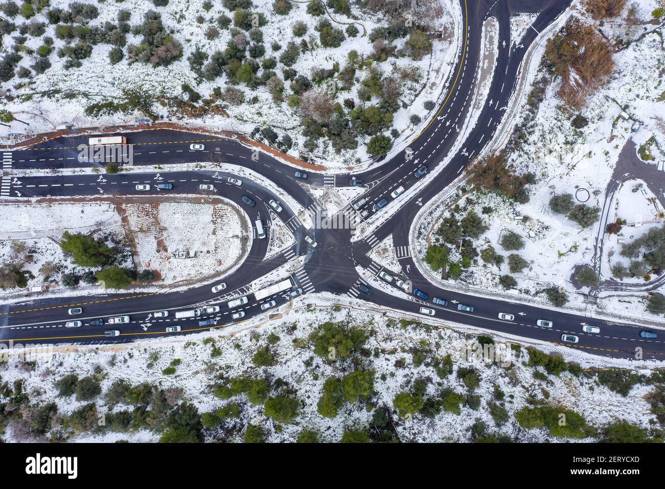 Traffic on a city junction surrounded by fresh fallen Snow, Aerial view ...