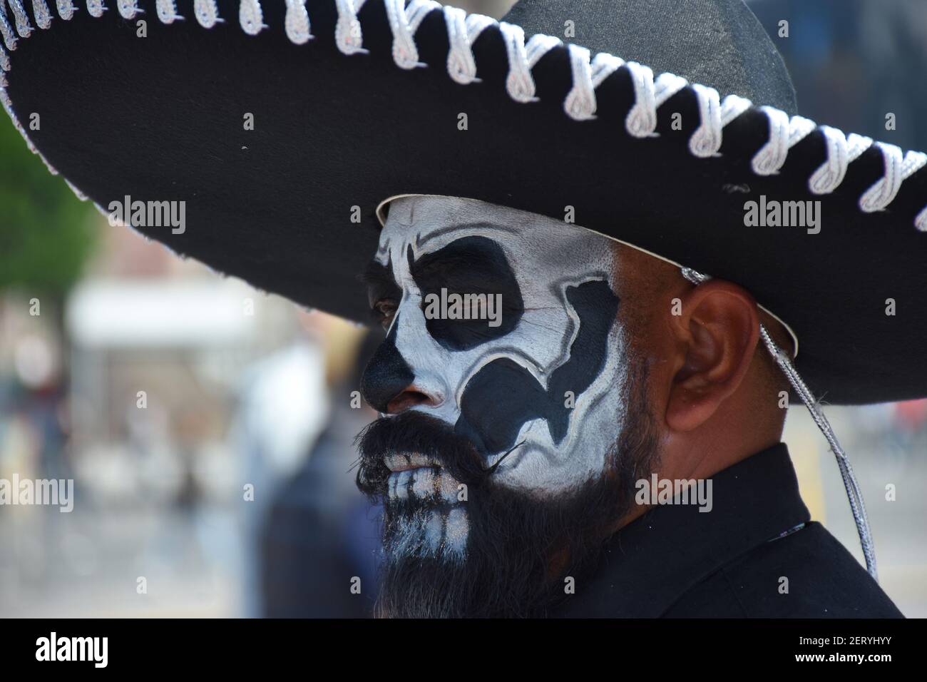 A Man dressed as Charro and the face painted as a skull looks during ...