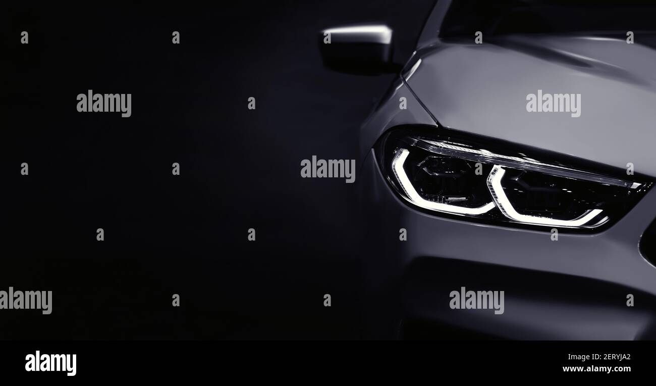 Detail on one of the LED headlights modern car on black background ...