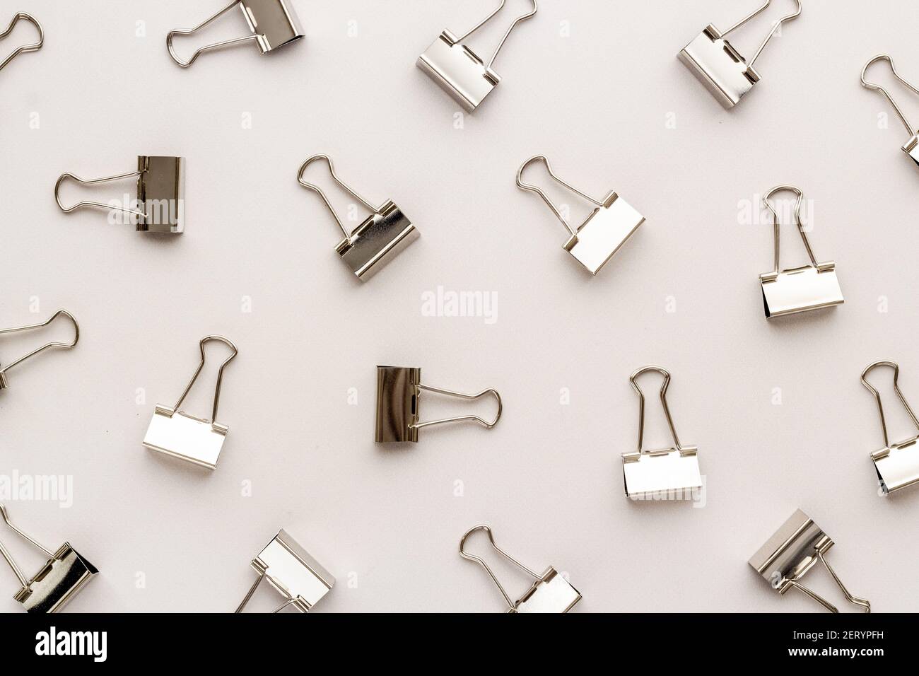 Flat lay of paper binder clips, office supplies pattern Stock Photo - Alamy