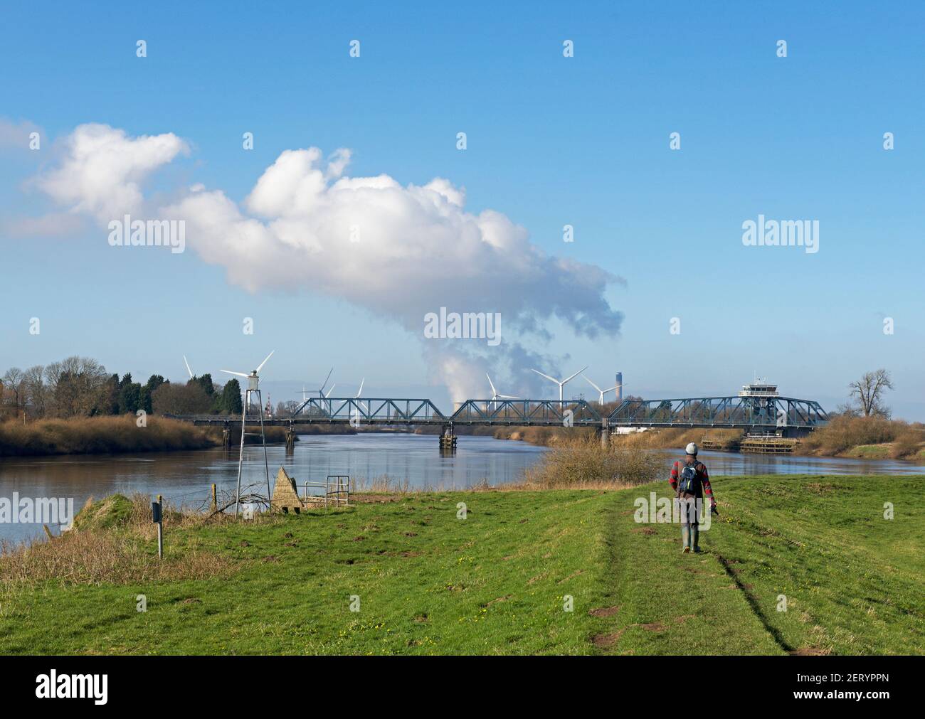 Walker on riverside path, approaching Boothferry Bridge spanning the ...