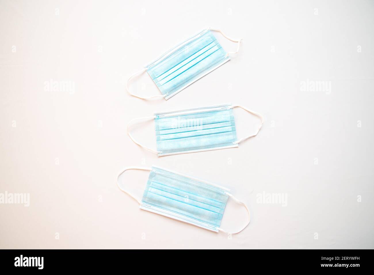 A top view of single-use surgical masks on a white surface Stock Photo ...