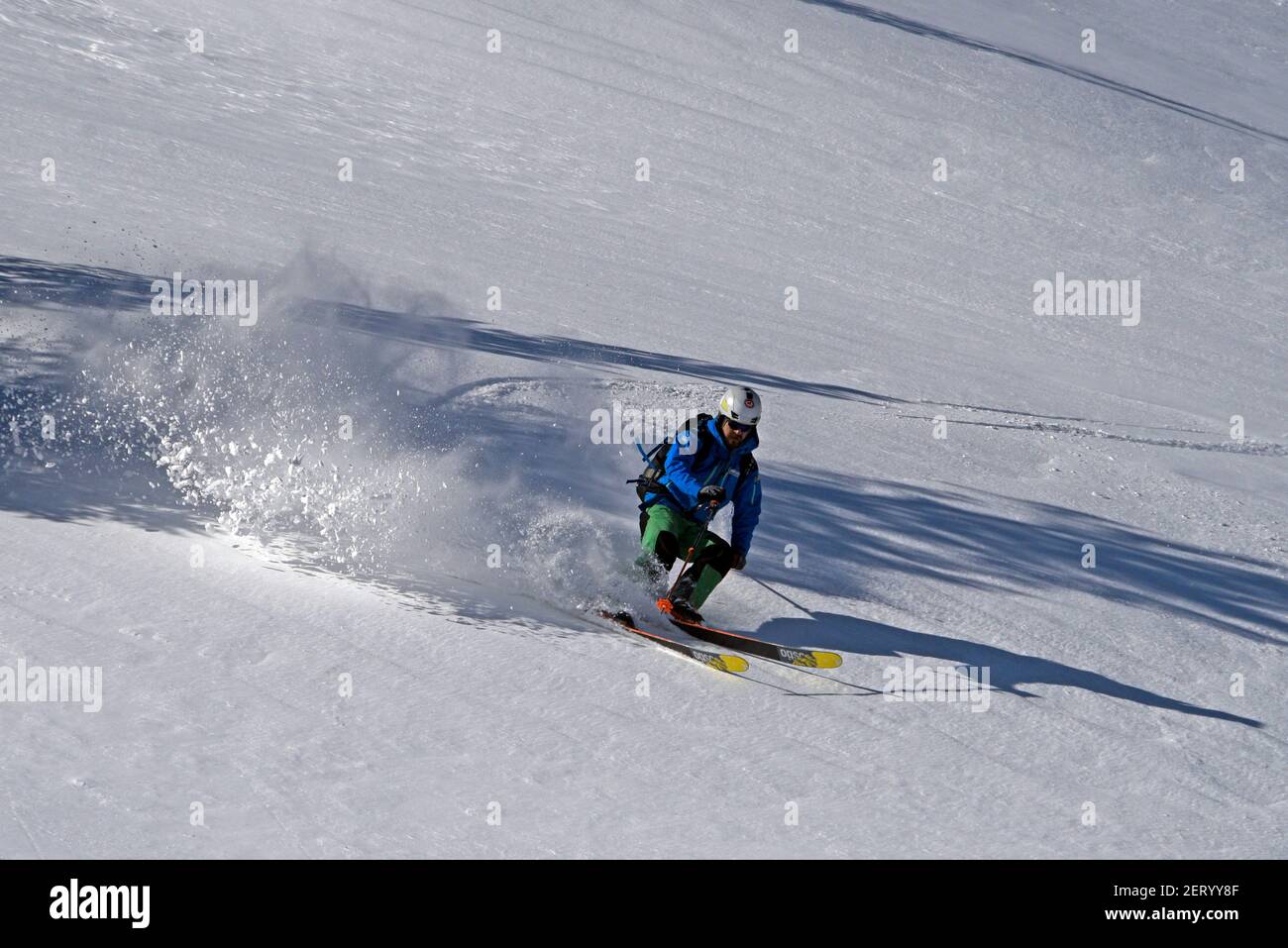WESTERN UKRAINE - FEBRUARY 21, 2021 - A skier speeds down the slope while on a ski tour from ...