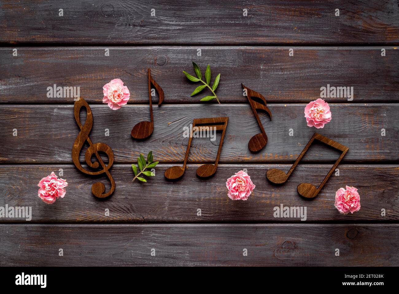 Musical wooden notes with flowers. Top view. Love songs concept Stock ...