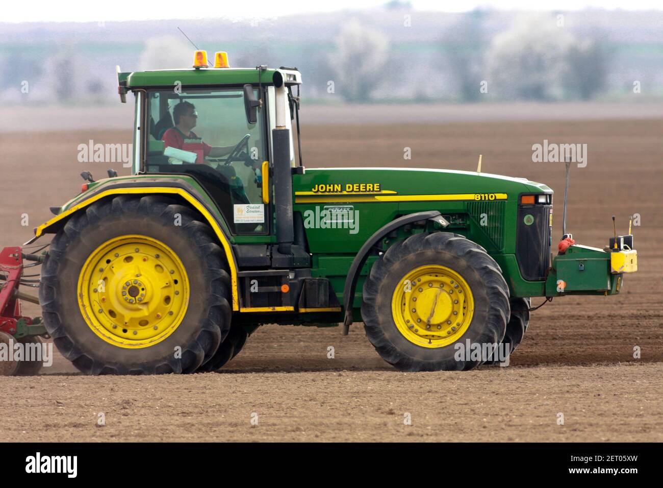 John Deere tractor farmer, spring seasonal works on soil field Stock ...