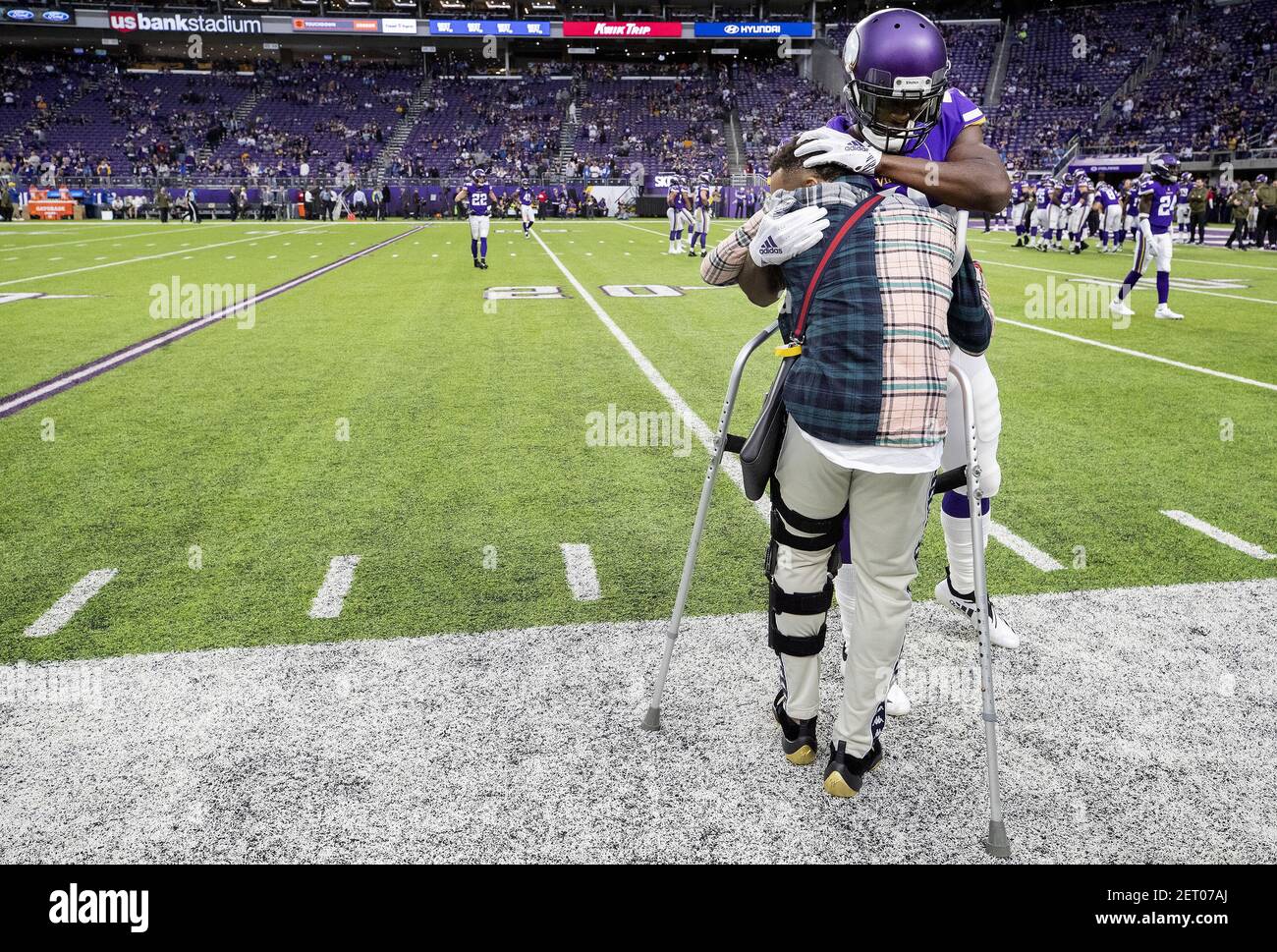 Injured Minnesota Vikings cornerback Mike Hughes gets a hug from Xavier ...