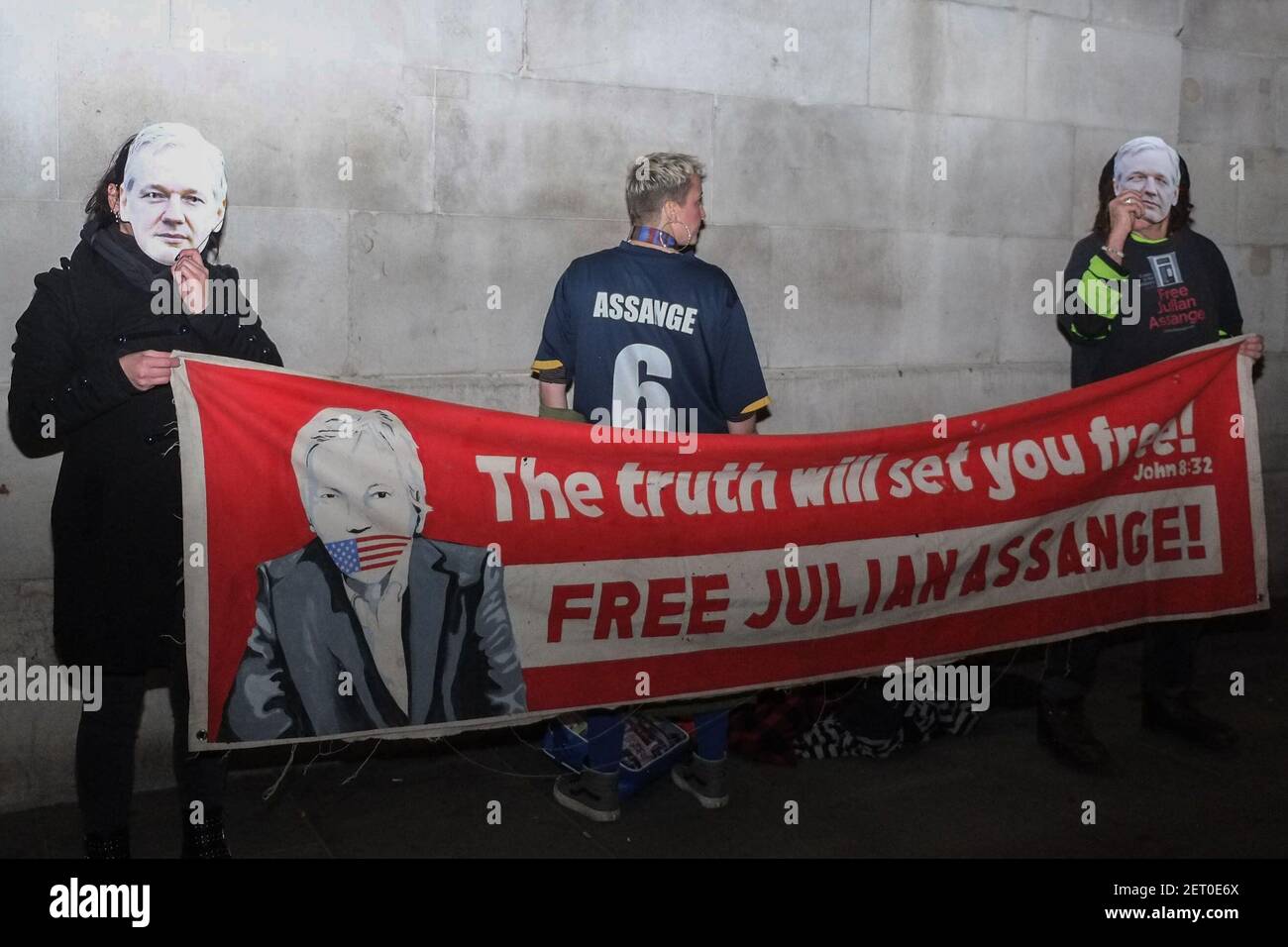 Protesters hold a a sign in support of Wikileaks founder Julian Assange ...