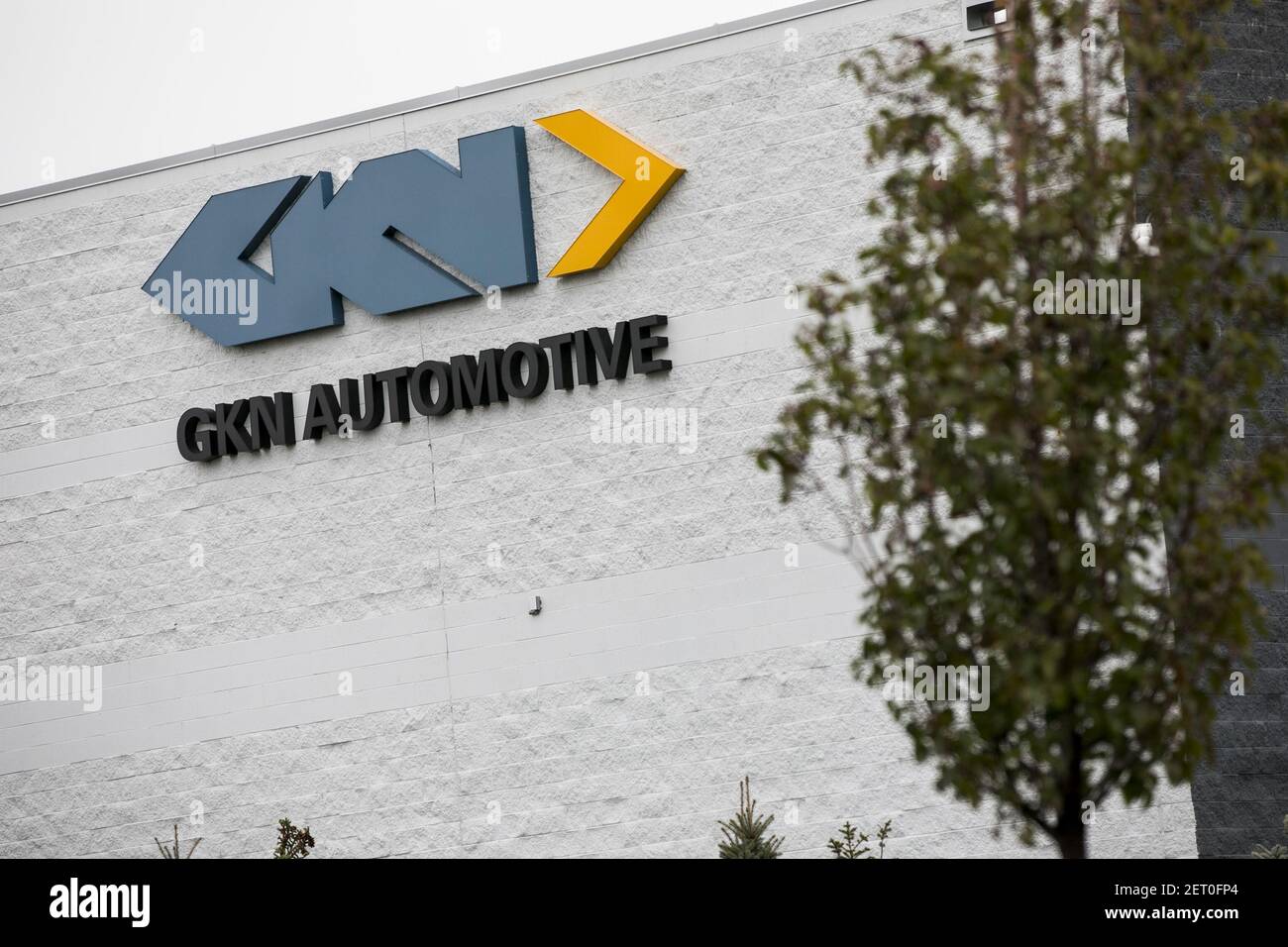 A logo sign outside of a facility occupied by GKN Automotive in Auburn ...