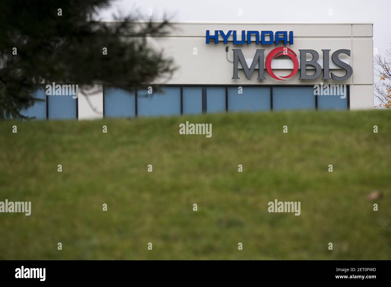 A logo sign outside of a facility occupied by Hyundai Mobis in Plymouth ...