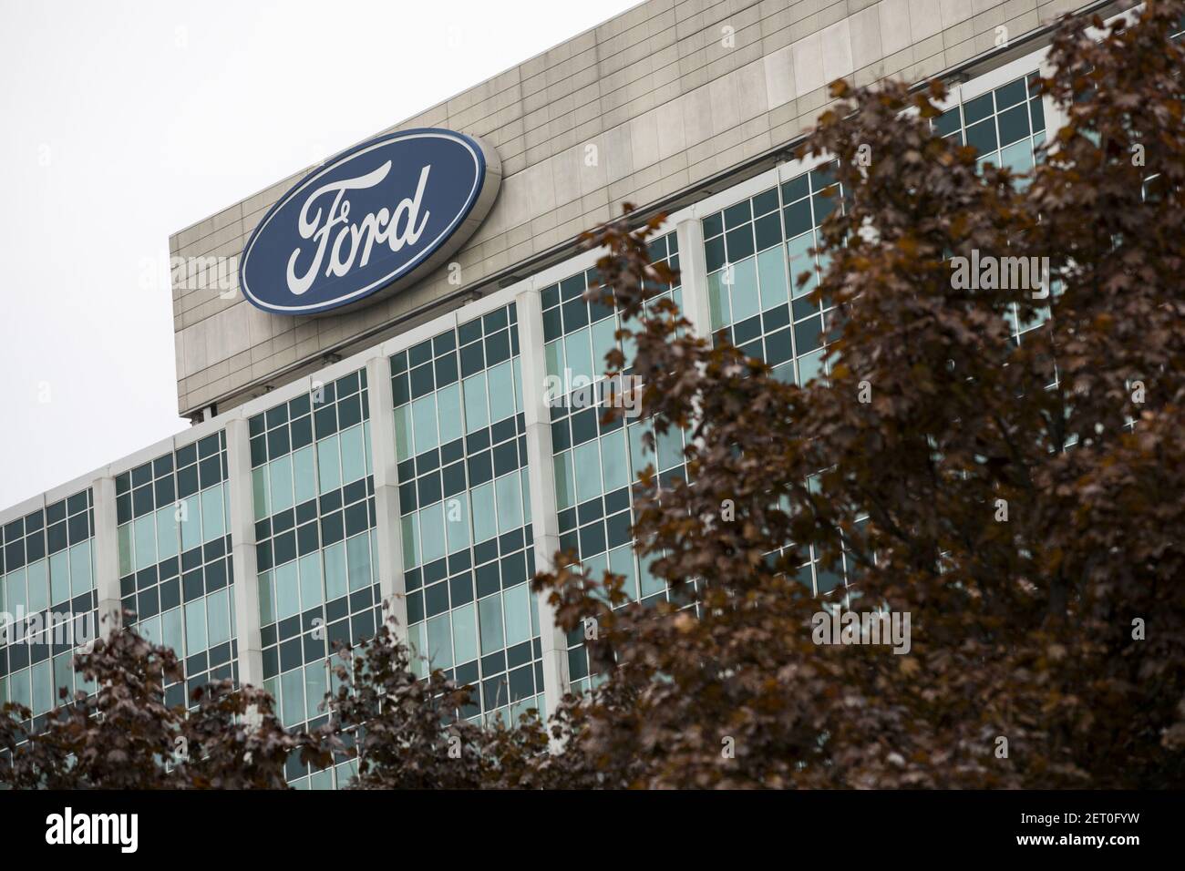 A logo sign outside of the headquarters of the Ford Motor Company in ...
